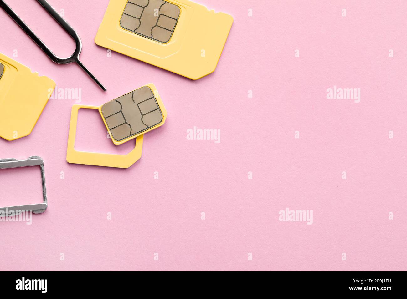 SIM card, tray and ejector on pink background, flat lay. Space for text ...