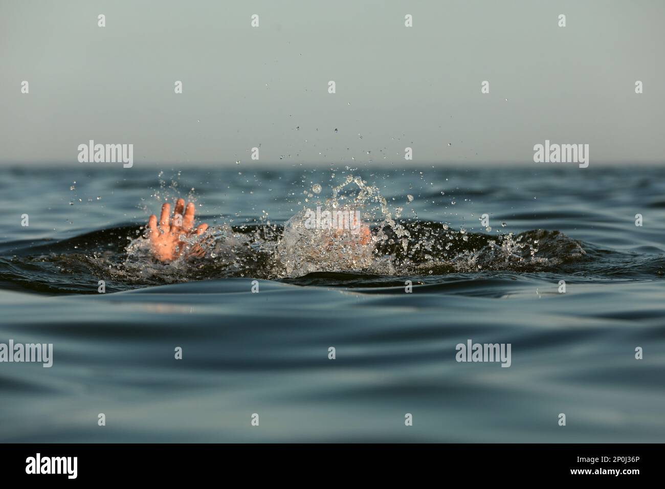 Drowning man reaching for help in sea Stock Photo - Alamy