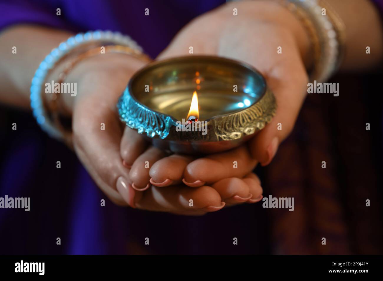 Diya in hands hi-res stock photography and images - Alamy