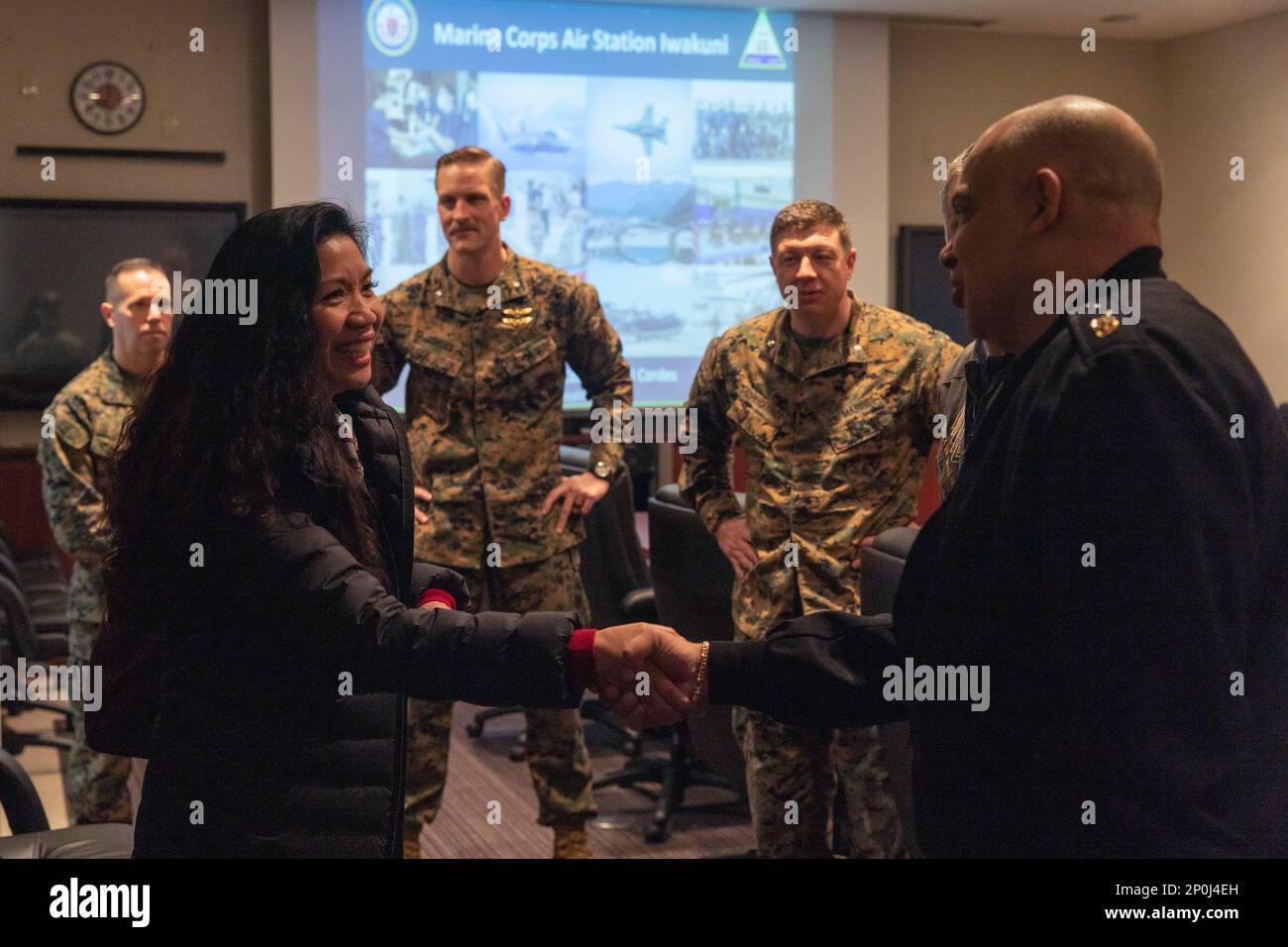 U.S. Navy Ombudsman-At-Large Junifer Thomas shakes hands with U.S. Navy ...