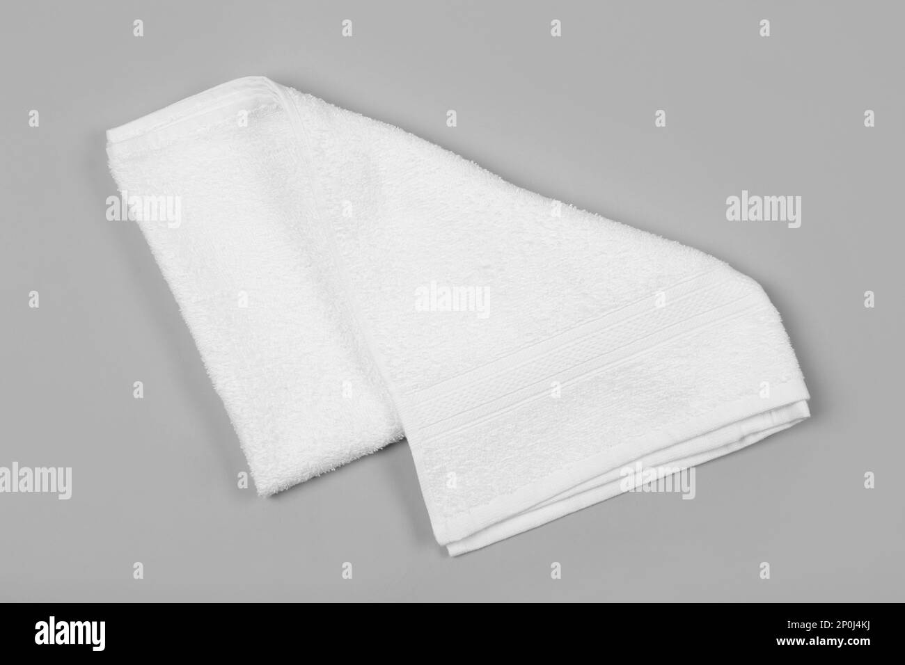 Folded white beach towel on light grey background, top view Stock Photo ...