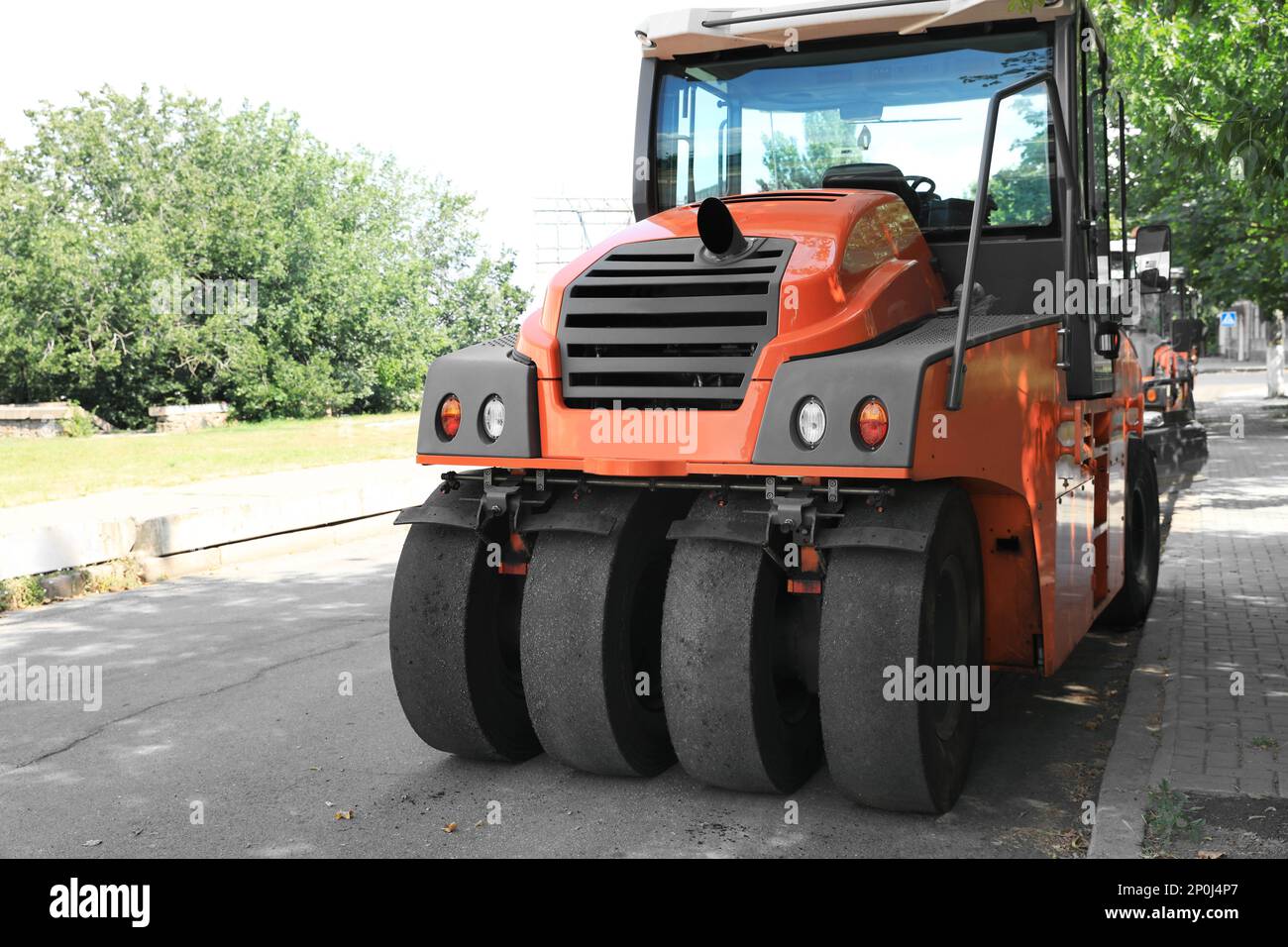 Modern roller on city street. Road repair service Stock Photo - Alamy