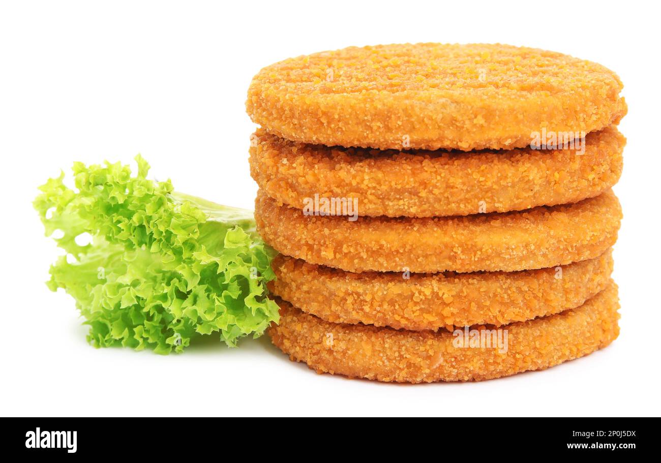 Uncooked breaded cutlets, tomato and lettuce on white background ...