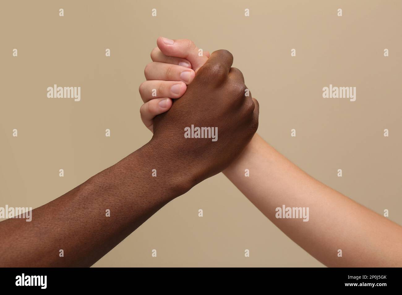 Two people clasp hands hi-res stock photography and images - Alamy