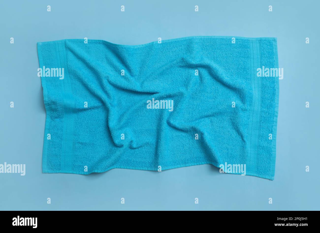 Crumpled soft beach towel on light blue background, top view Stock ...