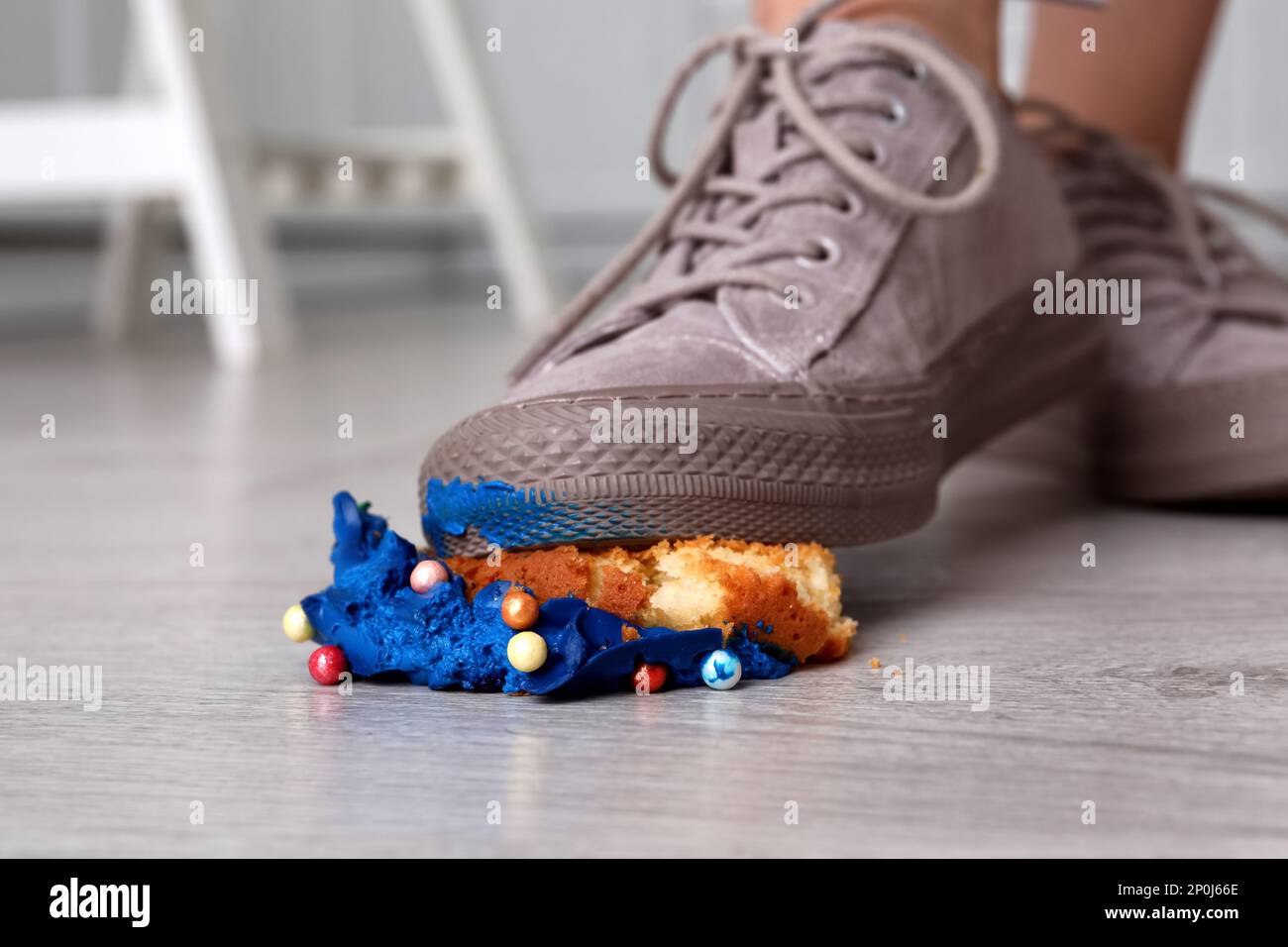 Woman stepping on dropped cupcake indoors, closeup. Troubles happen ...