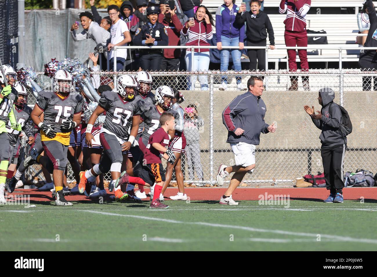 Curtis' head coach Peter Gambardella leads his team onto the field ...
