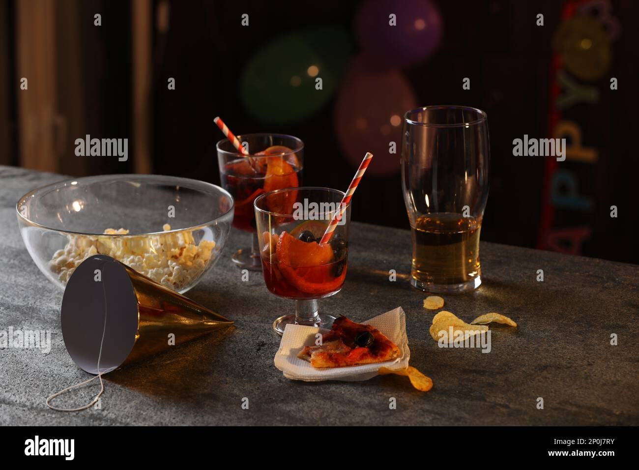 Messy table with drinks and food leftovers indoors. After party chaos ...
