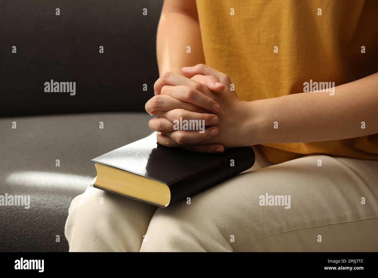 Religious woman praying over Bible indoors, closeup Stock Photo - Alamy