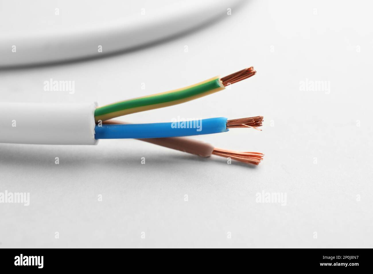 Closeup view of electrical power cables on white background Stock Photo ...