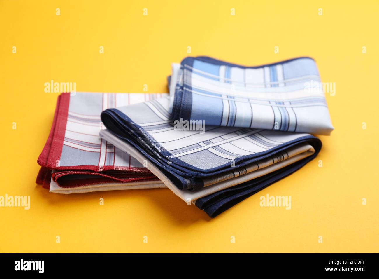 Different new stylish handkerchiefs on yellow background Stock Photo ...