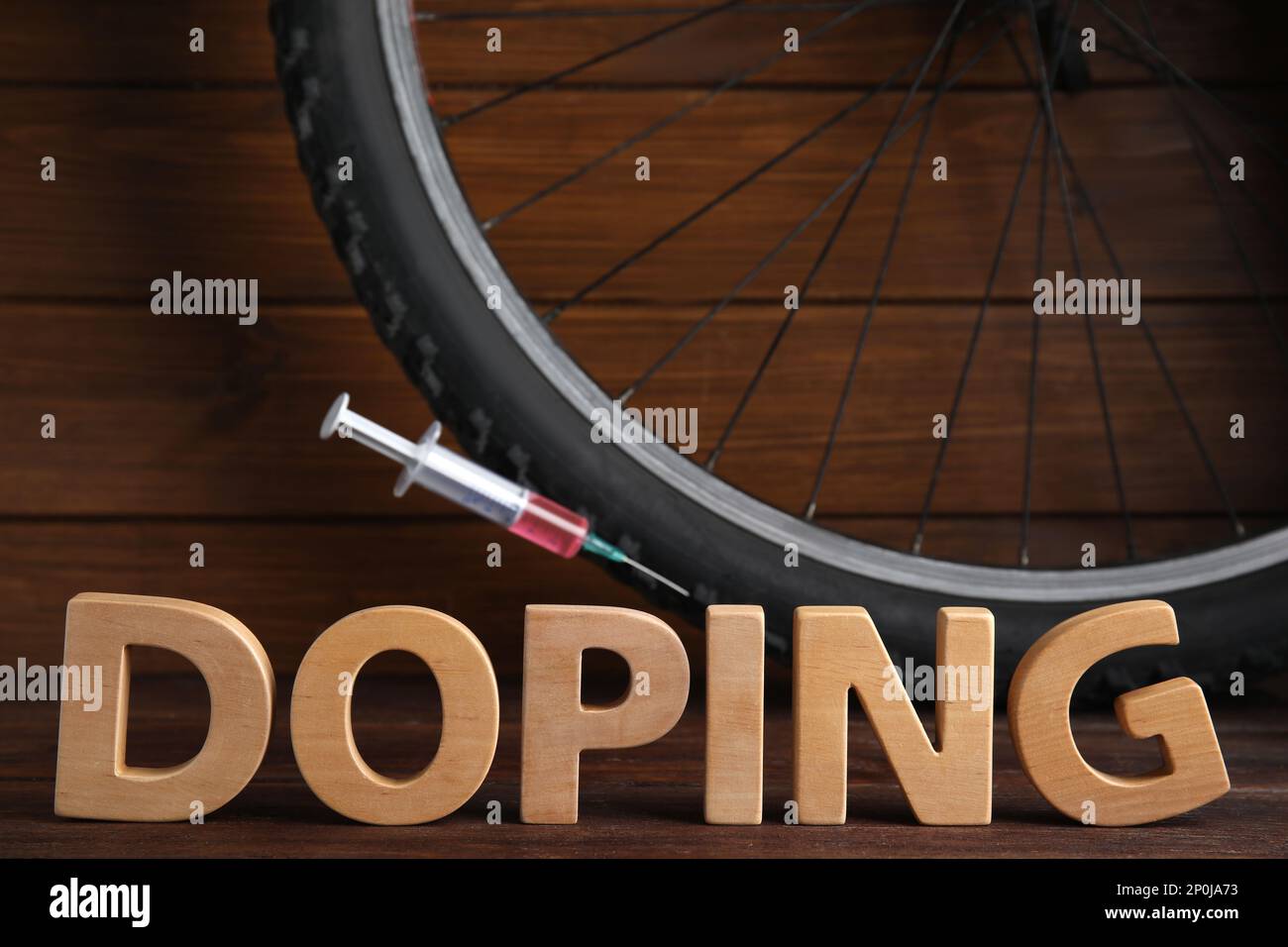 Word Doping, syringe and bicycle wheel on wooden background Stock Photo ...