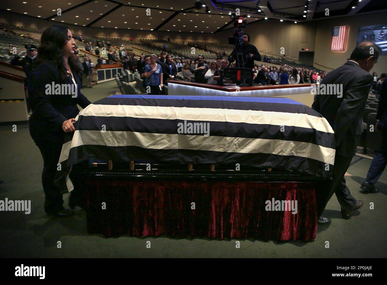 The coffin of San Antonio Police Detective Benjamin Marconi is wheeled ...