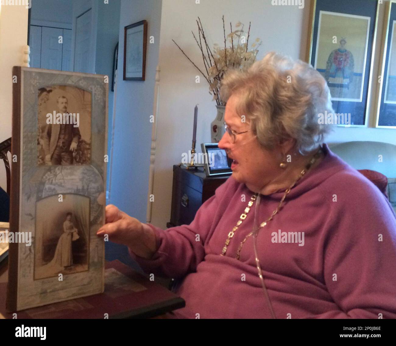 In a Nov. 10, 2016 photo, Rosemary Colby, 99, looks at family photos ...