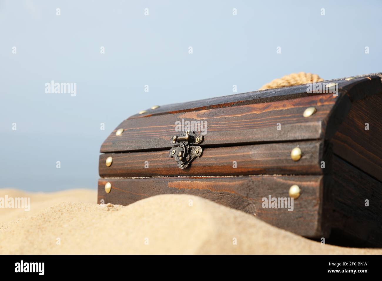 Closed wooden treasure chest on sandy beach, closeup Stock Photo - Alamy