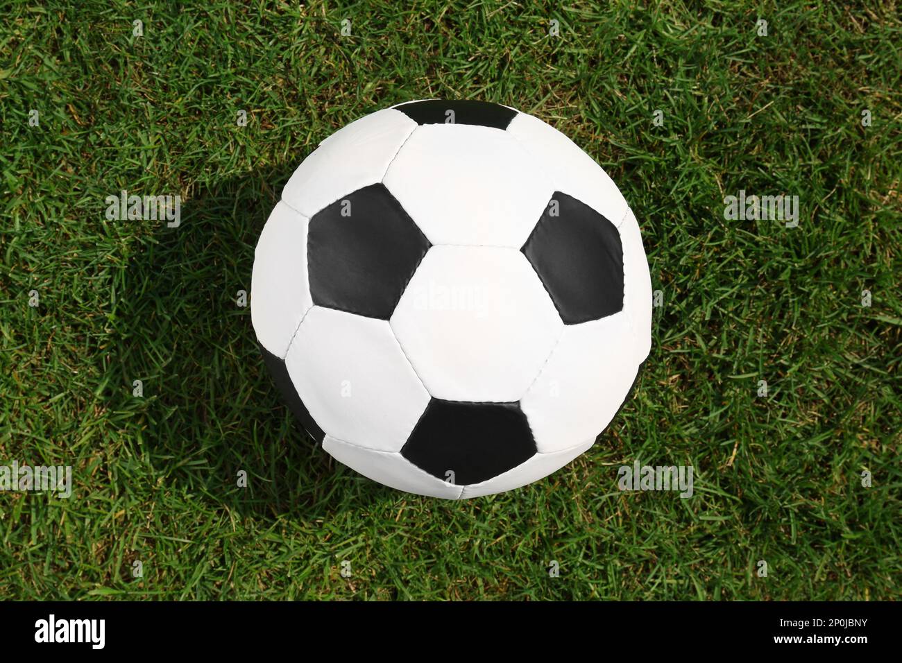 Football ball on green grass, top view Stock Photo - Alamy
