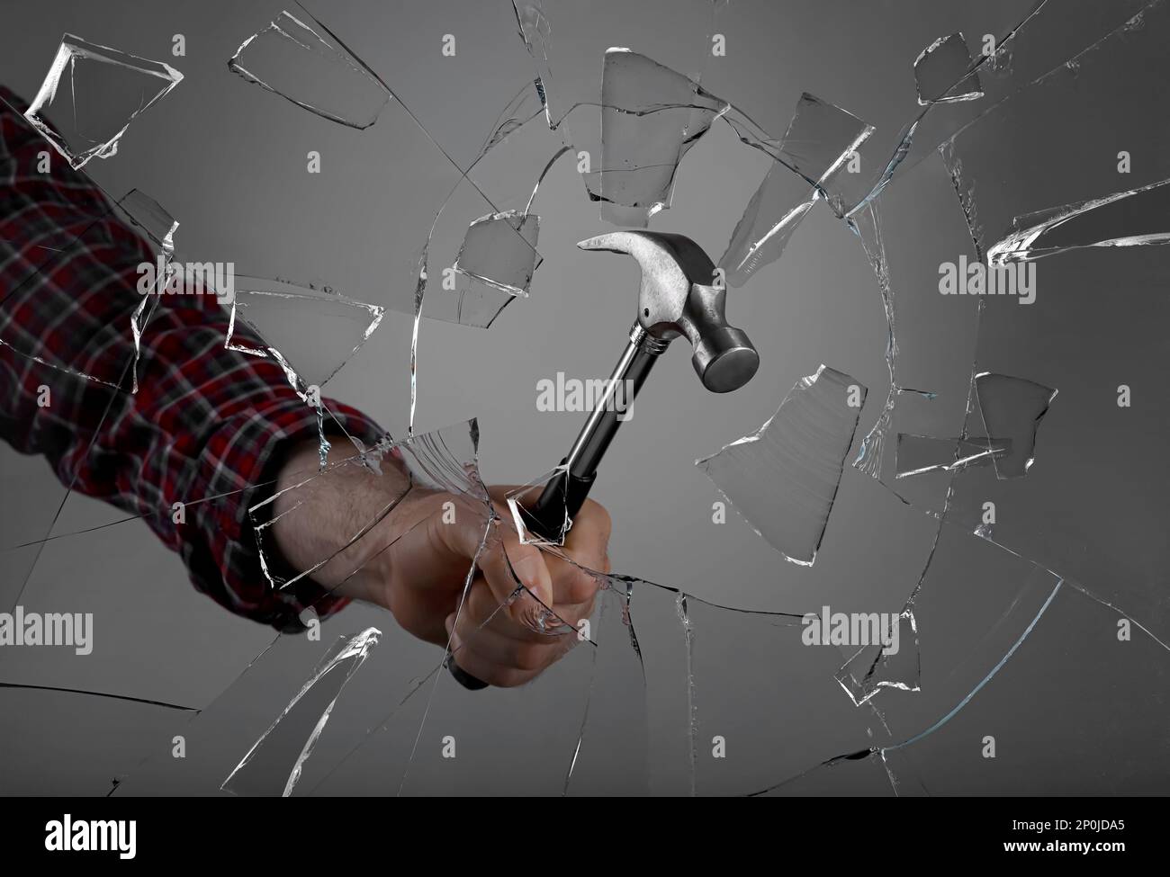 Man breaking window with hammer on dark grey background, closeup Stock ...