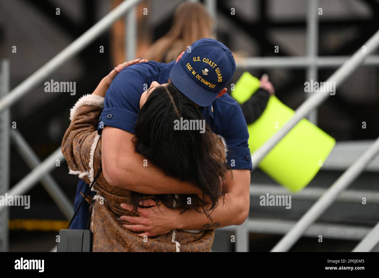 A crew member aboard the CGC Warren Deyampert (WPC-1151) embraces a ...