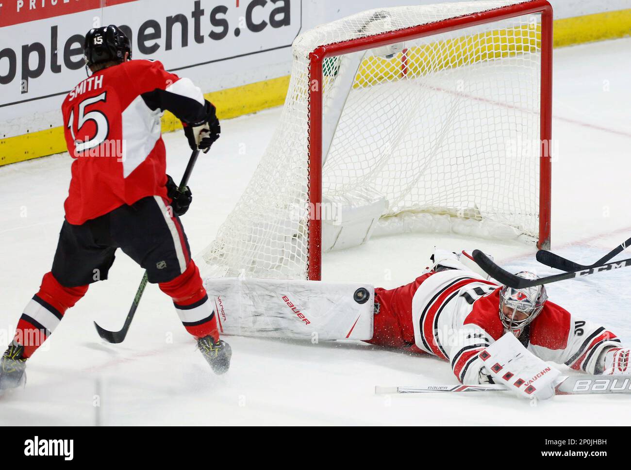 Carolina Hurricanes goaltender Cam Ward (30) makes a save on Ottawa Senators' Zack Smith (15 ...