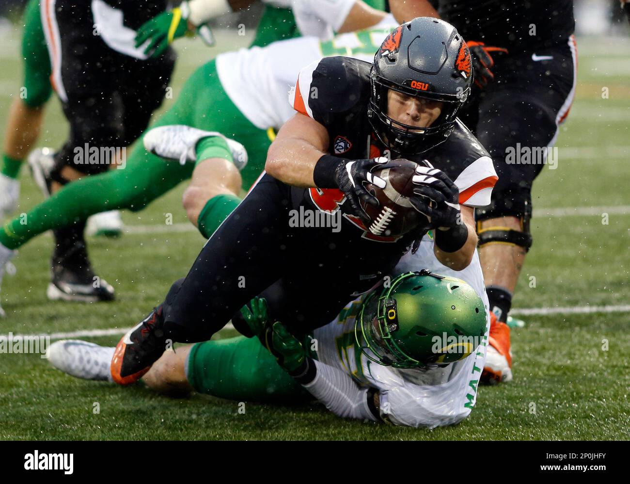 Oregon State running back Ryan Nall, top, dives over Oregon's Danny ...
