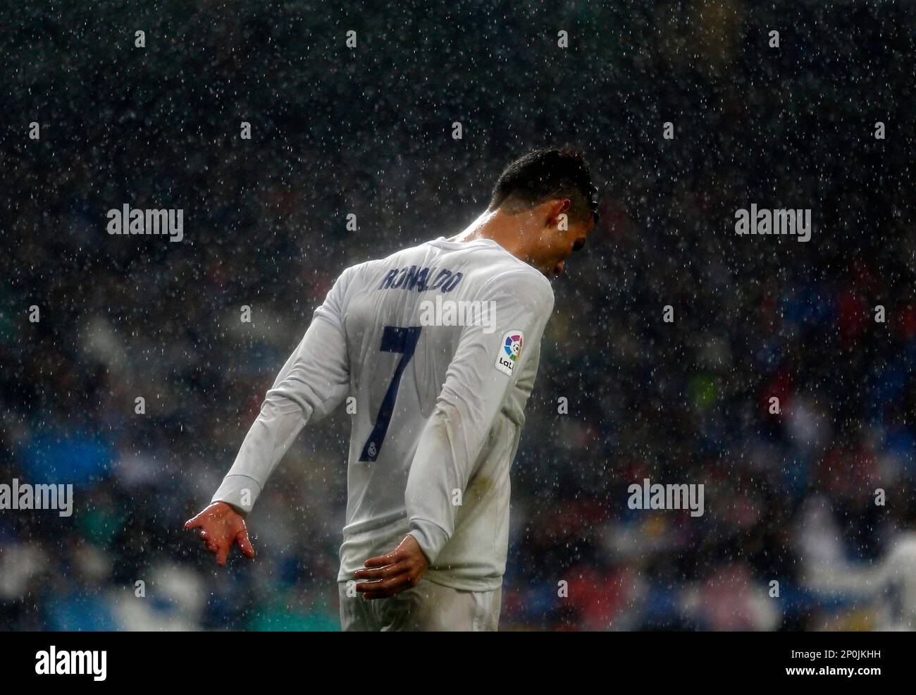 Real Madrid's Cristiano Ronaldo walks along the pitch under a heavy ...