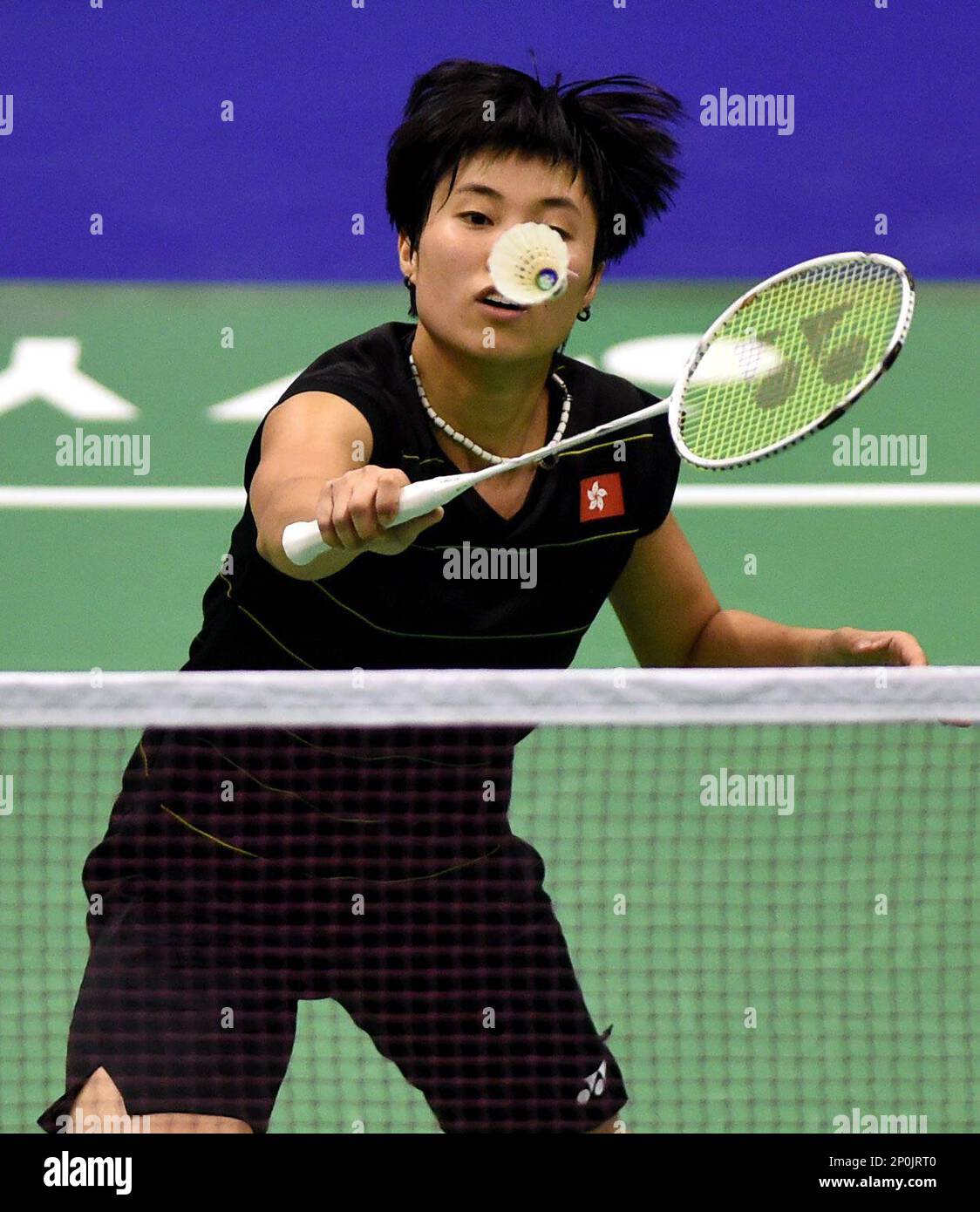 Yip Pui-yin of Hong Kong plays a return shot to Carolina Marin of Spain ...