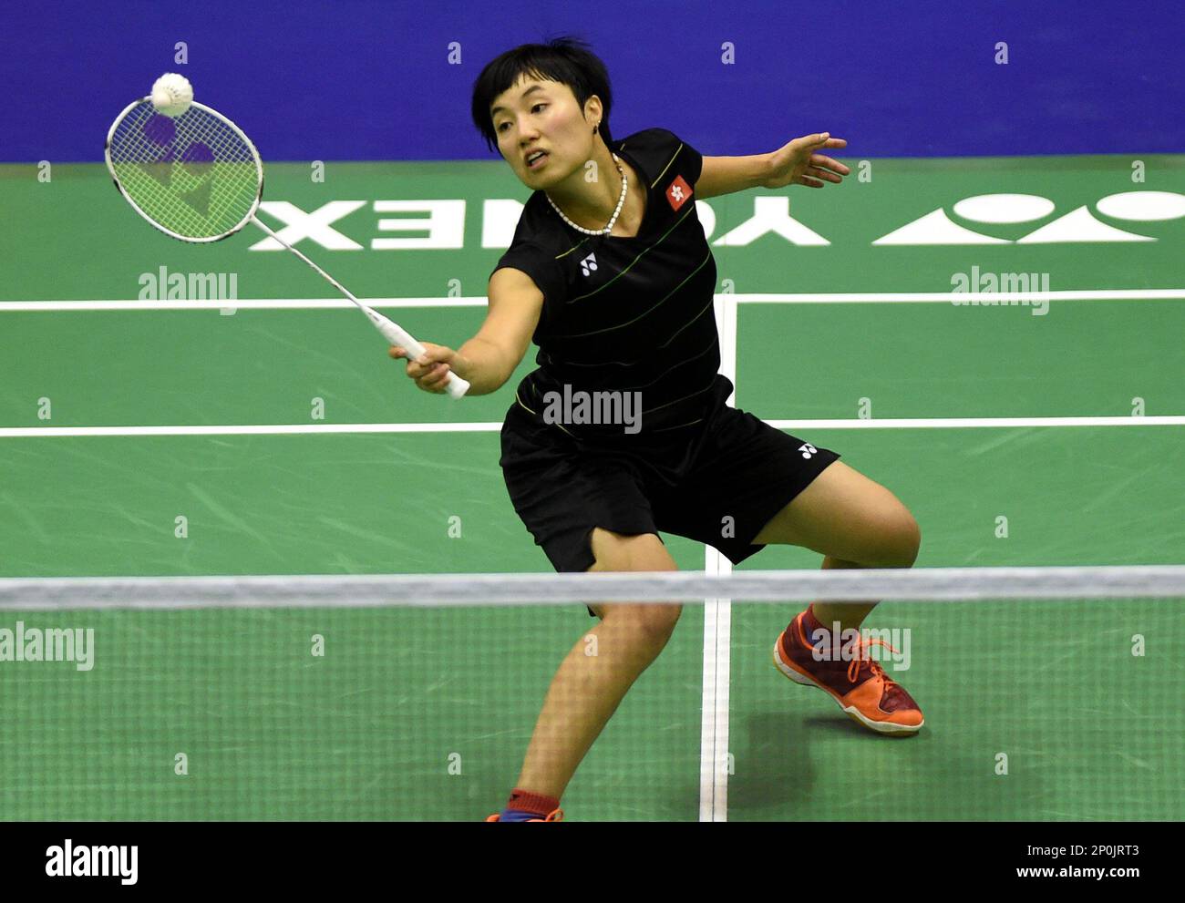 Yip Pui-yin of Hong Kong plays a return shot to Carolina Marin of Spain ...