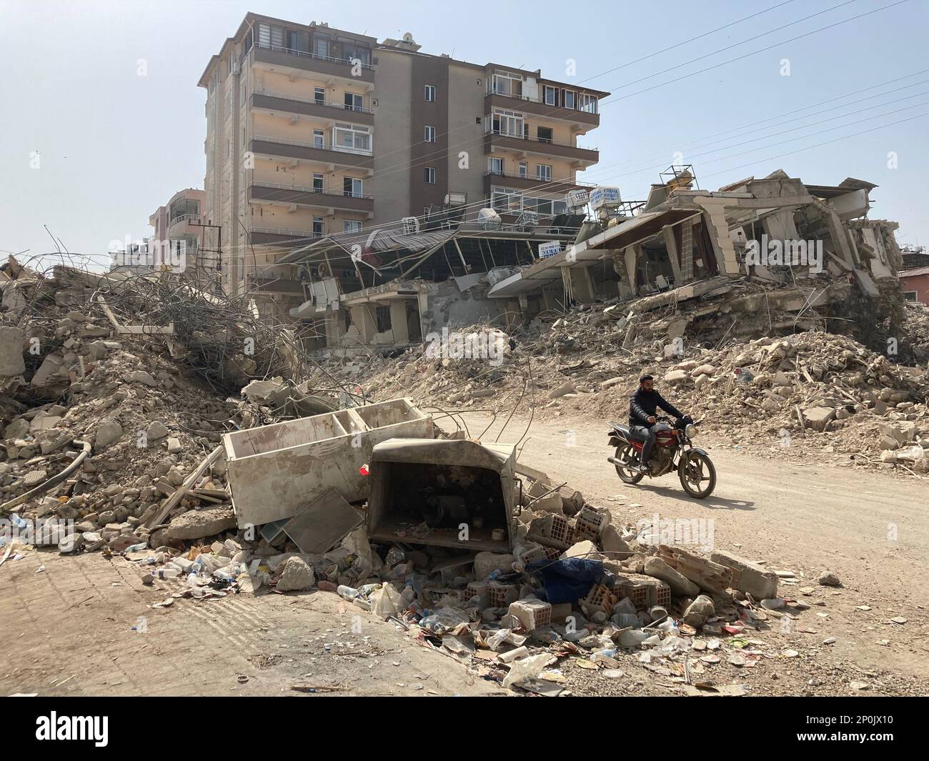Kirikhan, Turkey. 01st Mar, 2023. A man rides a motorcycle between ...