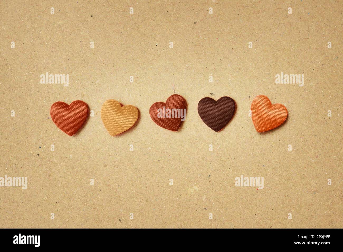 Hearts in skin colors on recycled paper background - Stop racism ...