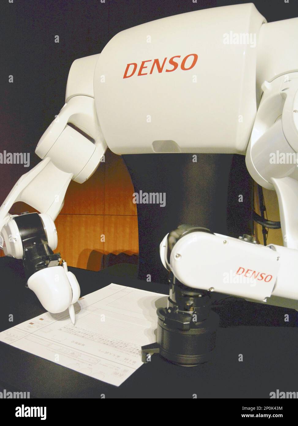 A robot writes Torobo-kun's answers at a demonstration event in Tokyo ...