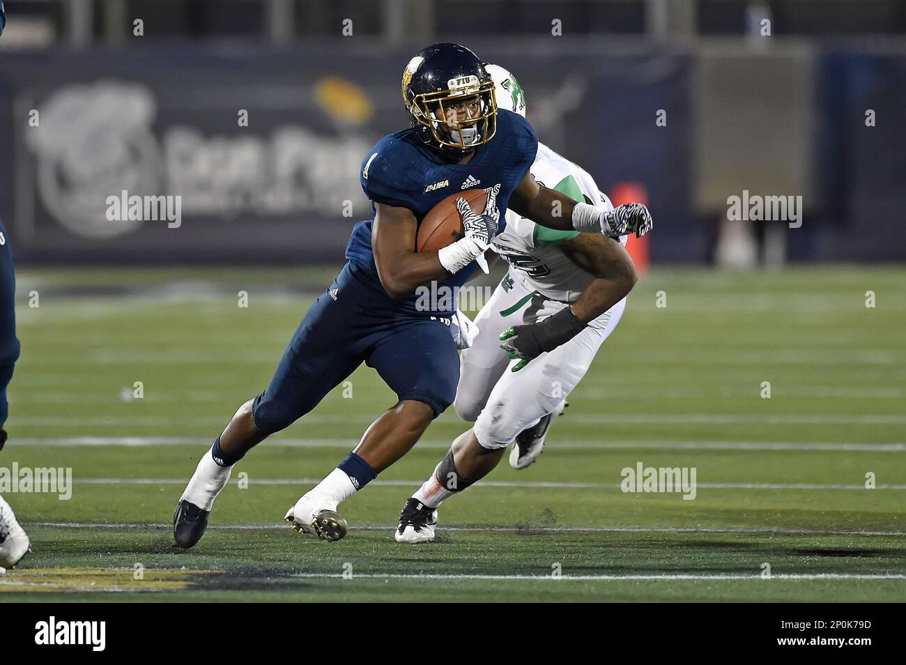MIAMI, FL - NOVEMBER 19: FIU running back Alex Gardner (1) evades Marshall linebacker Frankie ...