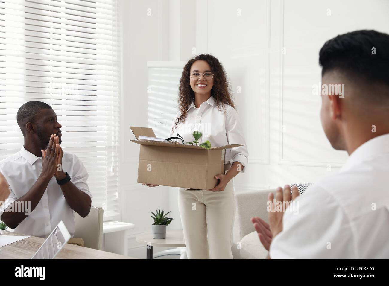 Group of coworkers welcoming new employee in office Stock Photo - Alamy