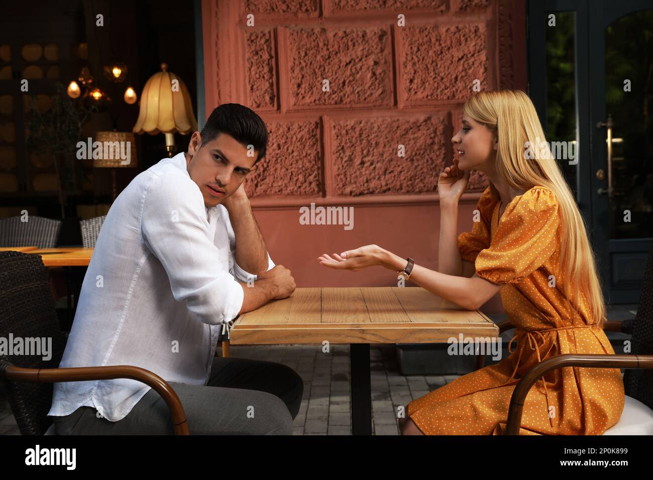 Man having boring date with talkative woman in outdoor cafe Stock Photo ...