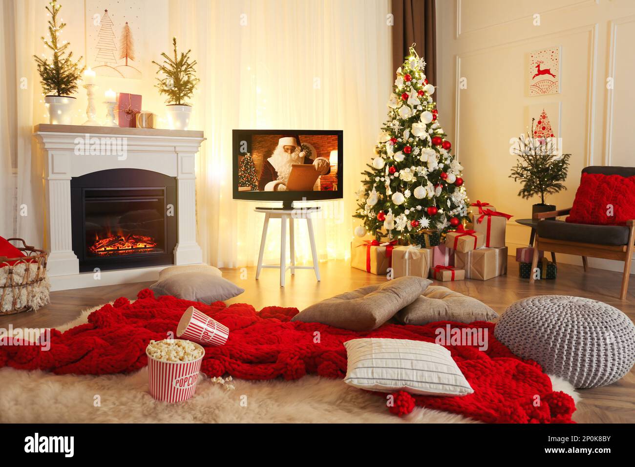 Stylish living room interior with TV set, Christmas tree and fireplace ...