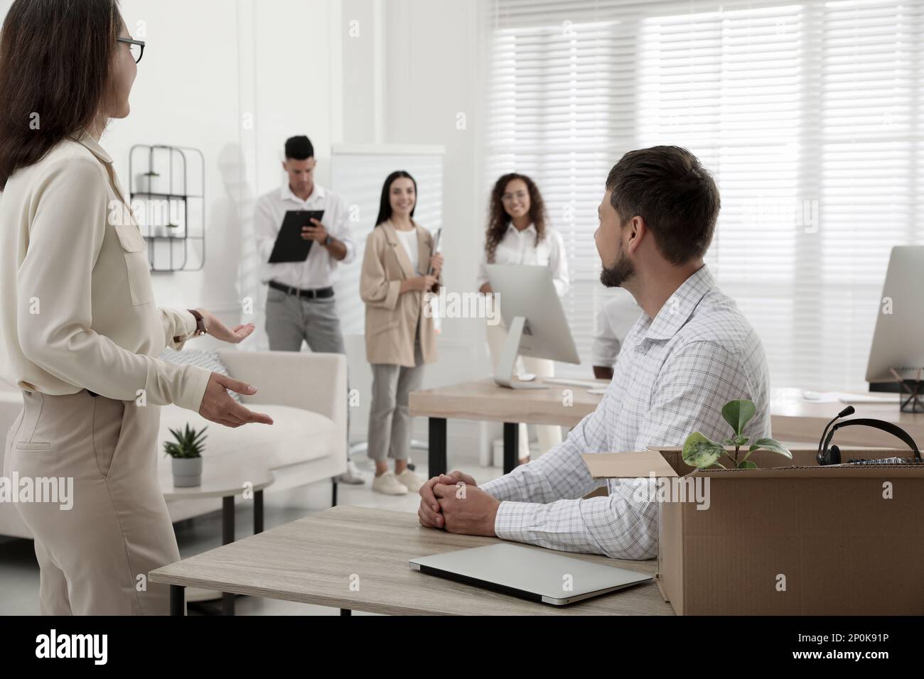 Boss introducing new employee to coworkers in office Stock Photo - Alamy