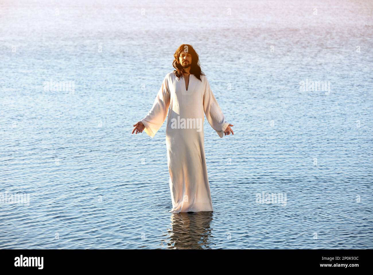 Jesus Christ in water lit by morning sun Stock Photo - Alamy