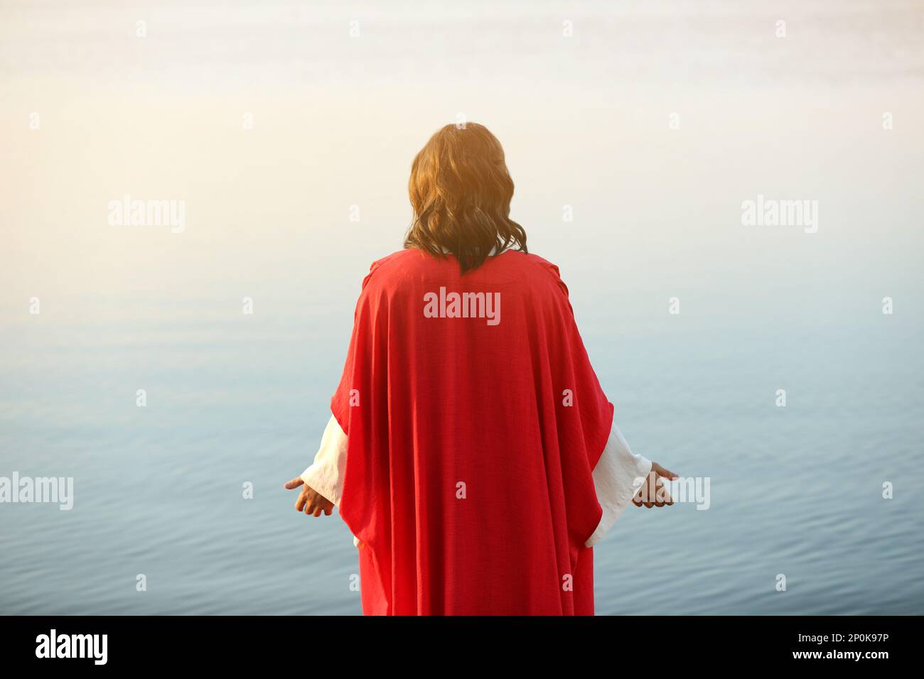 Jesus Christ near water outdoors, back view Stock Photo - Alamy