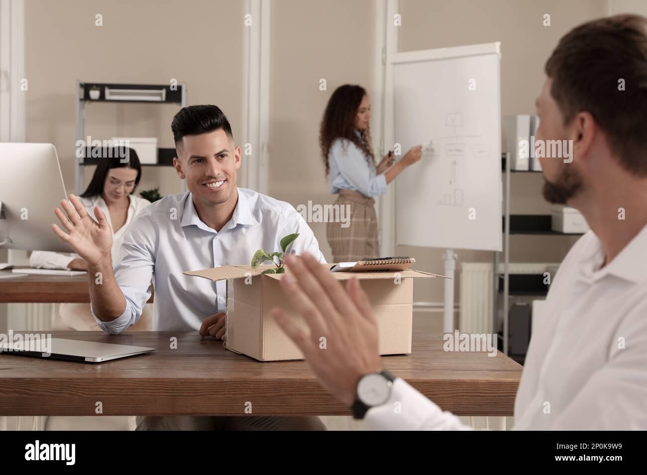 Employee greeting new coworker in modern office Stock Photo - Alamy