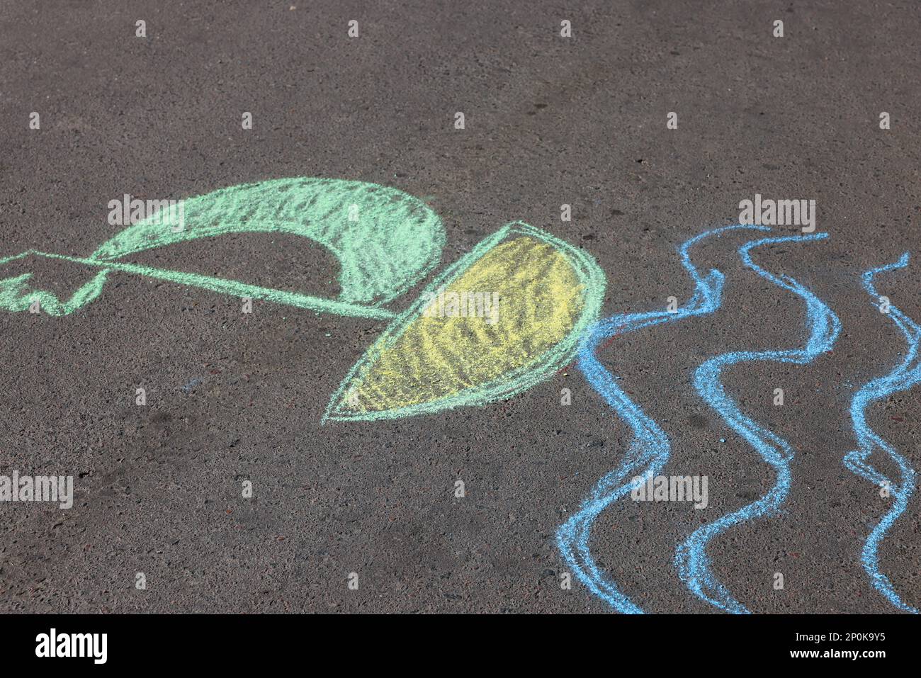 Child's chalk drawing of boat on asphalt Stock Photo - Alamy