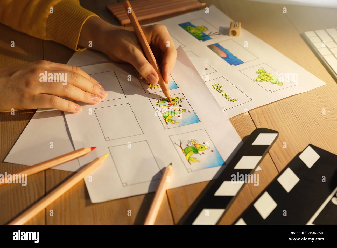 Woman drawing cartoon sketches at workplace, closeup. Pre-production ...