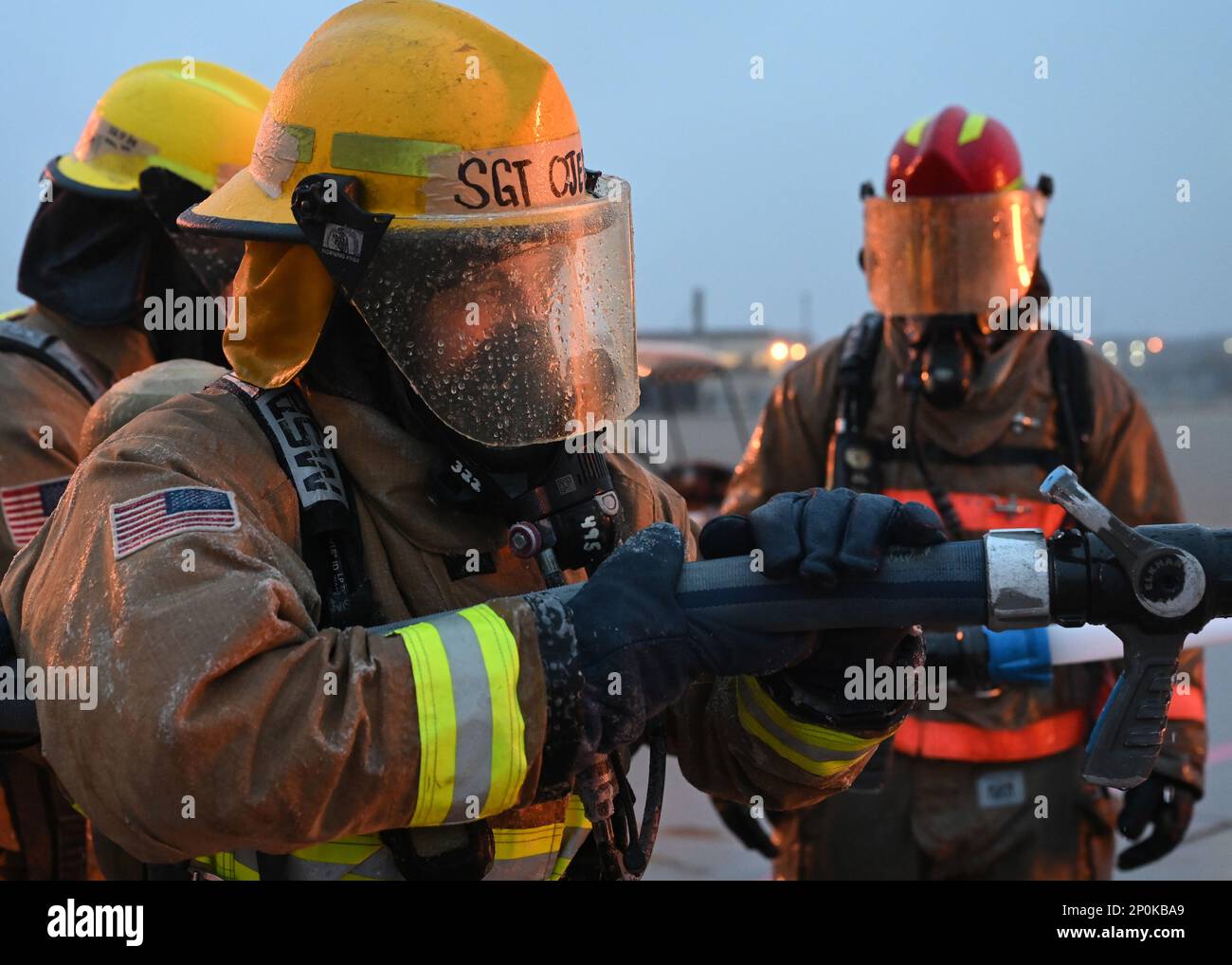 A fire apprentice course student controls a gas cylinder fire during a ...