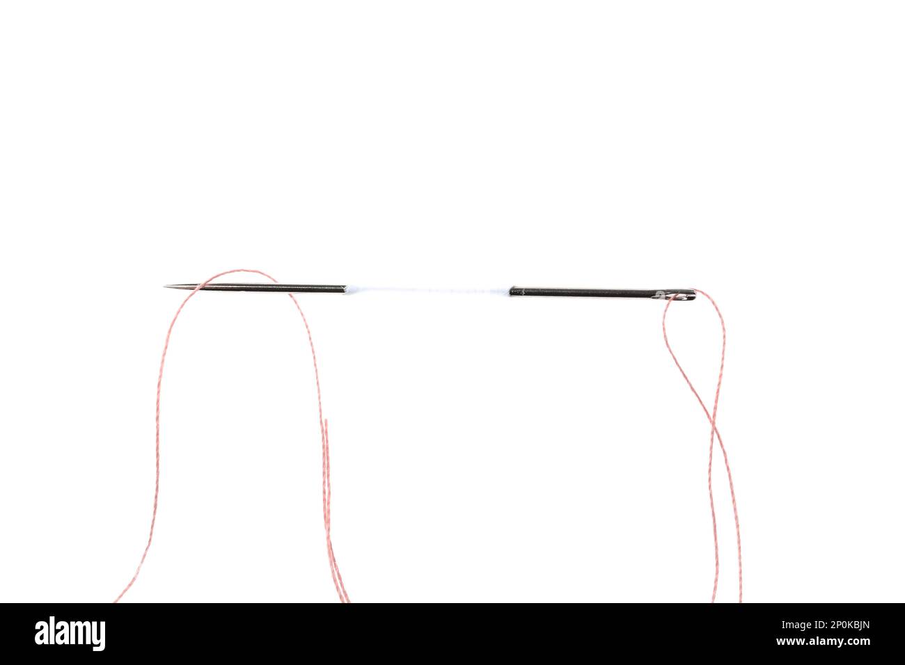 Sewing needle with thread piercing white paper, top view Stock Photo ...