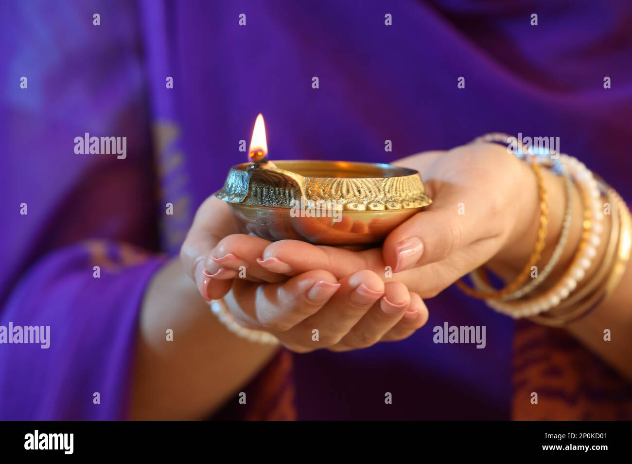 Woman holding diya hi-res stock photography and images - Alamy