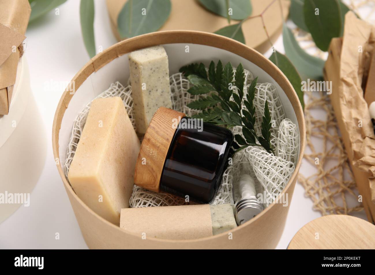 Cardboard box with eco friendly personal care products on white ...