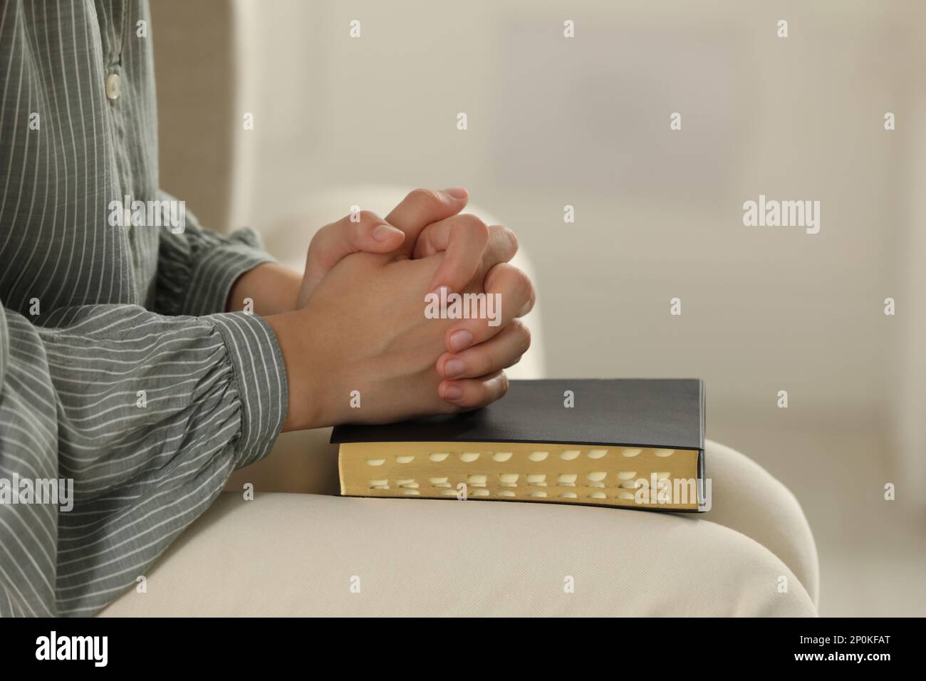 Religious woman praying over Bible indoors, closeup Stock Photo - Alamy