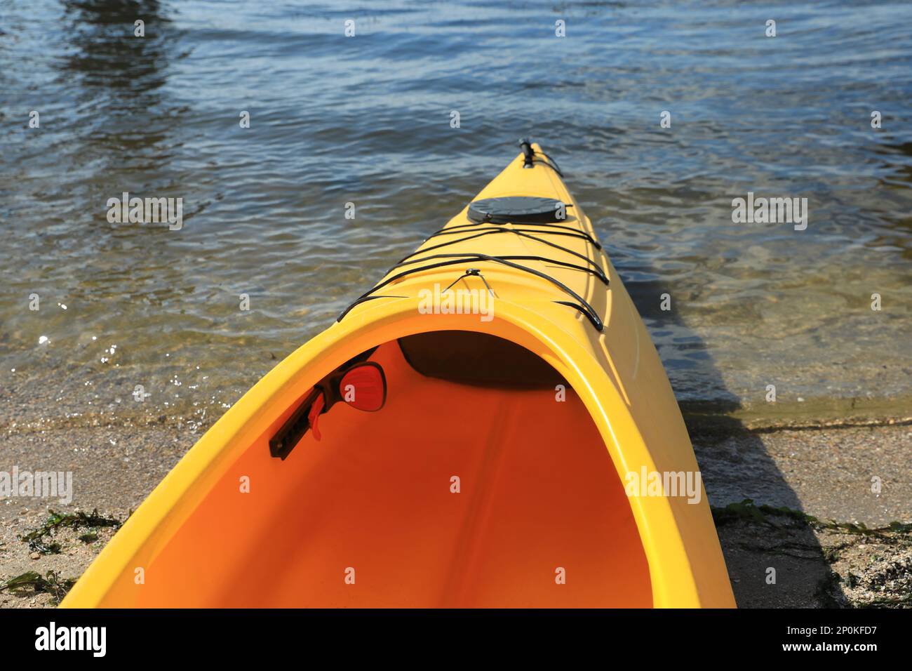 Yellow kayak on beach near river, closeup. Summer camp activity Stock ...