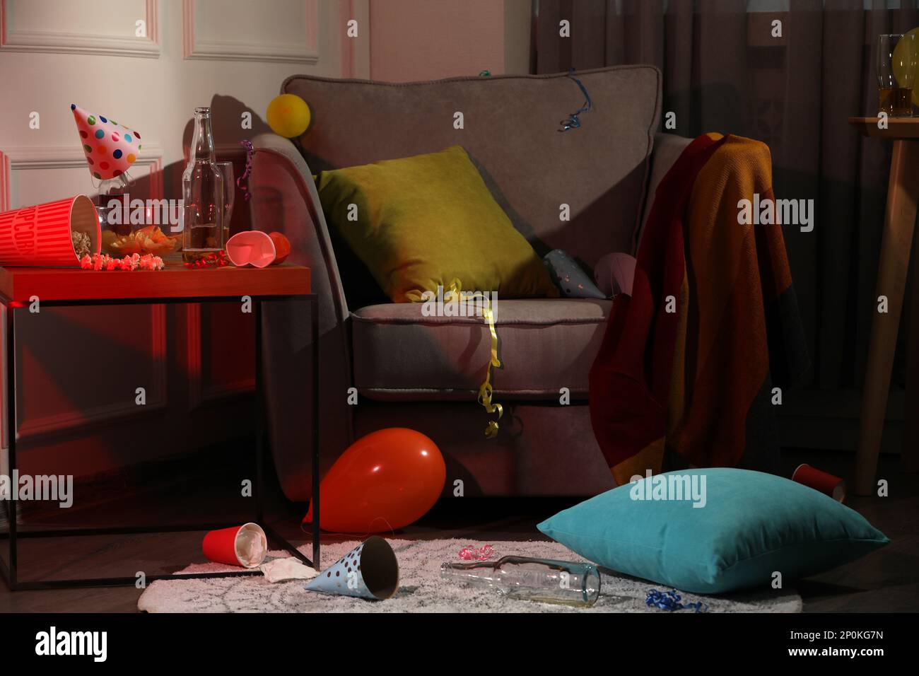 Armchair and dirty table in messy room after party Stock Photo - Alamy