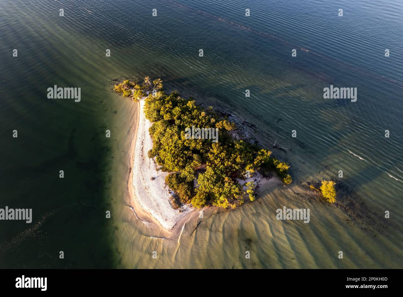 An aerial view of a small island surrounded by waters in North Palm ...