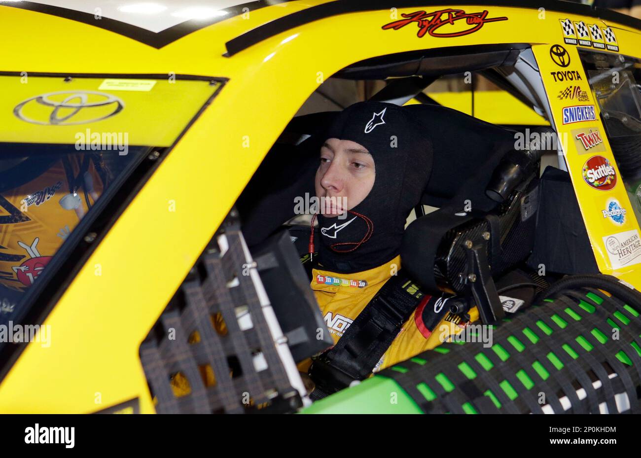 Race driver Kyle Busch sits in his car before NASCAR Sprint Cup Series ...