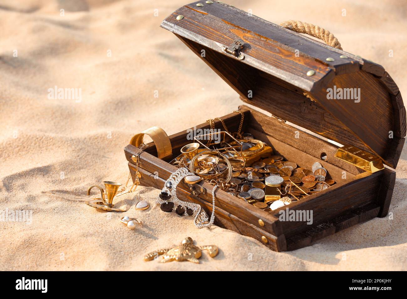 Open wooden treasure chest on sand, space for text Stock Photo - Alamy